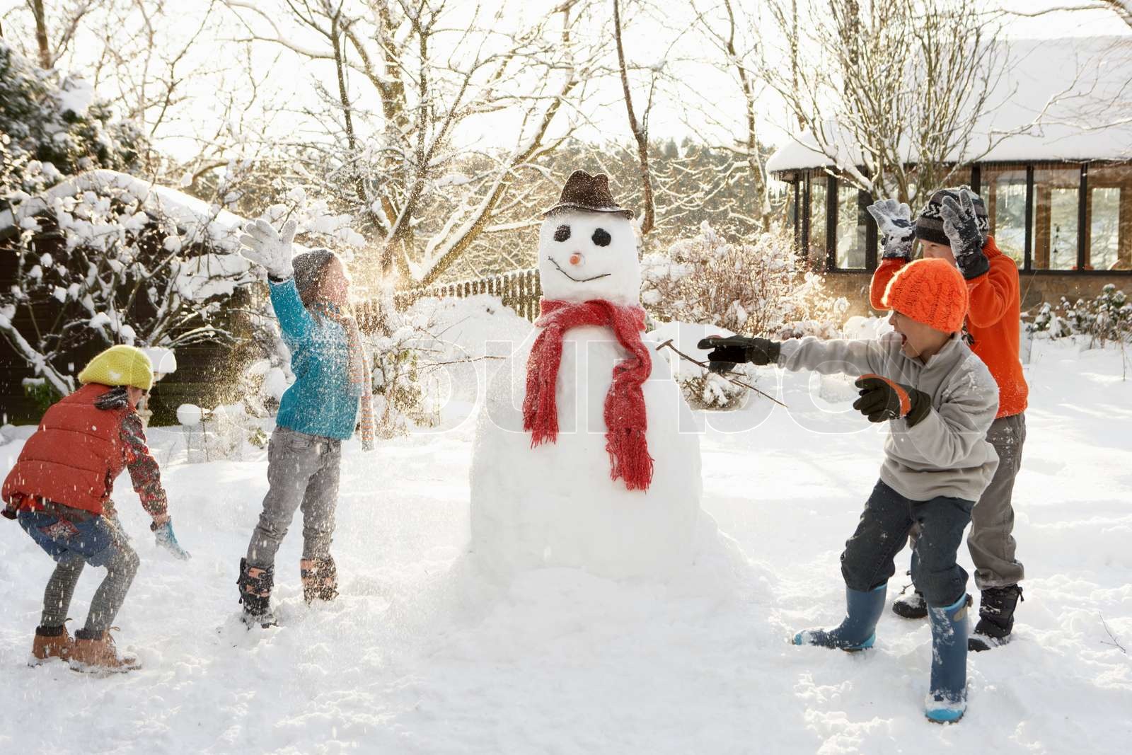 Mother And Children Building Snowman In Garden | Stock image | Colourbox