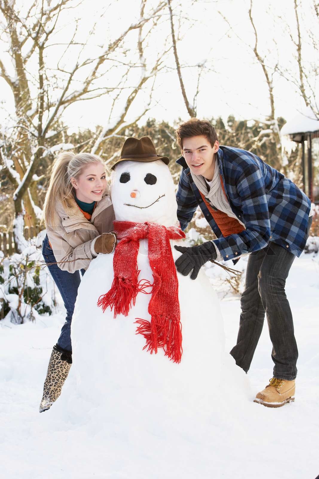Teenage Couple Building Snowman | Stock image | Colourbox
