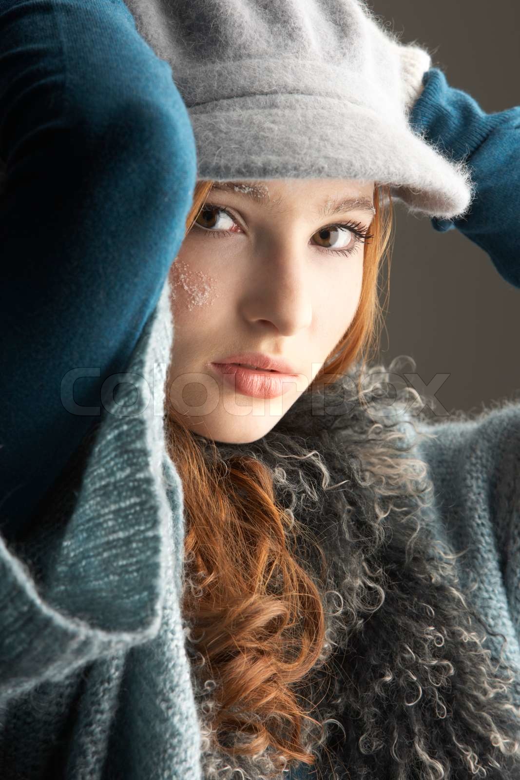 Fashionable Teenage Girl Wearing Cap And Knitwear In Studio | Stock ...