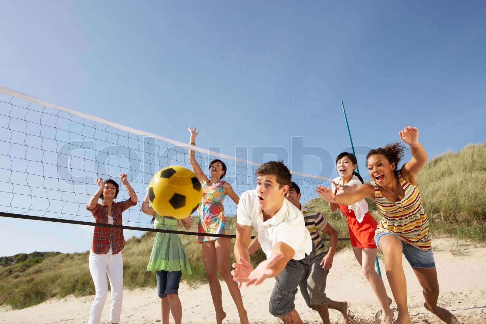 Group Of Teenage Friends Playing Volleyball On Beach | Stock image ...