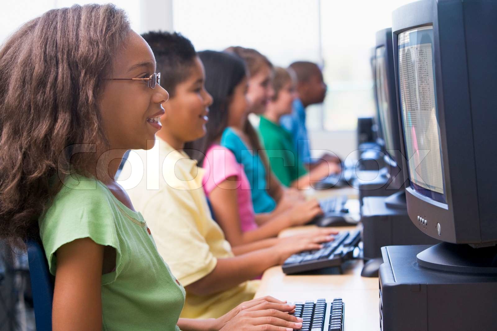 Female pupil in elementary school computer class | Stock image | Colourbox