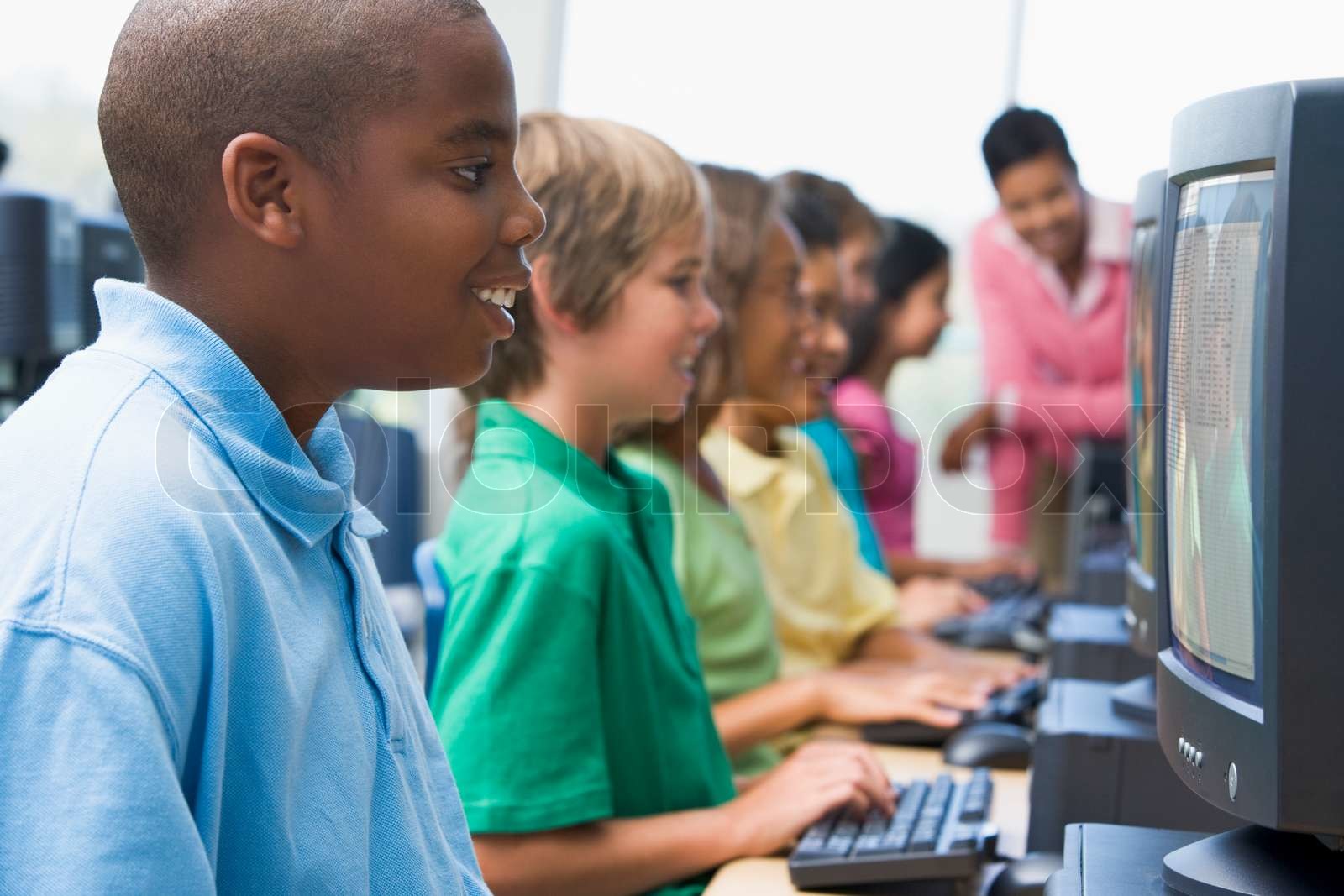Male pupil in elementary school computer class | Stock image | Colourbox