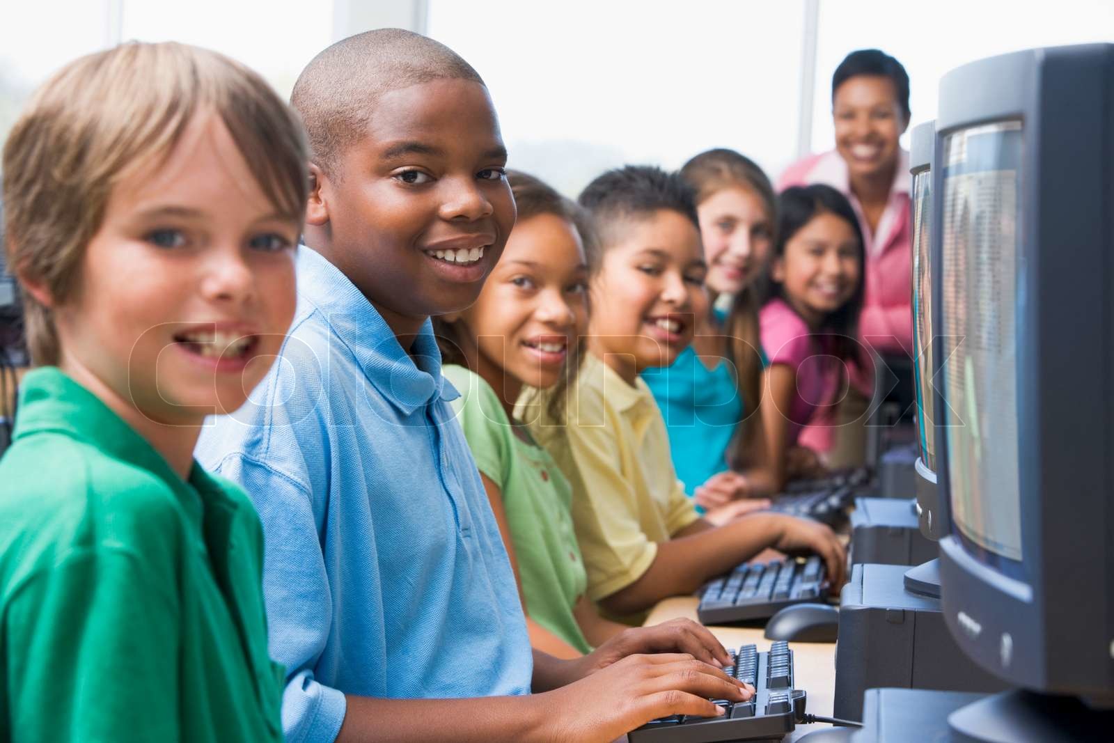 Elementary school computer class looking to camera | Stock image ...