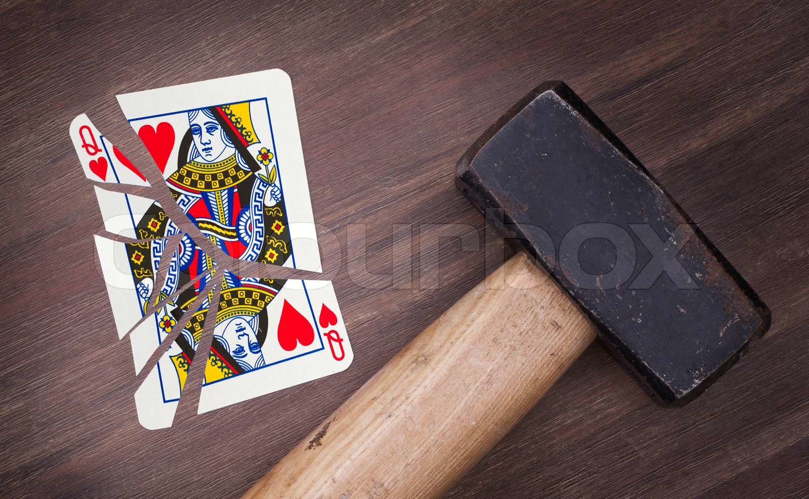 Hammer with a broken card, queen of hearts | Stock image | Colourbox