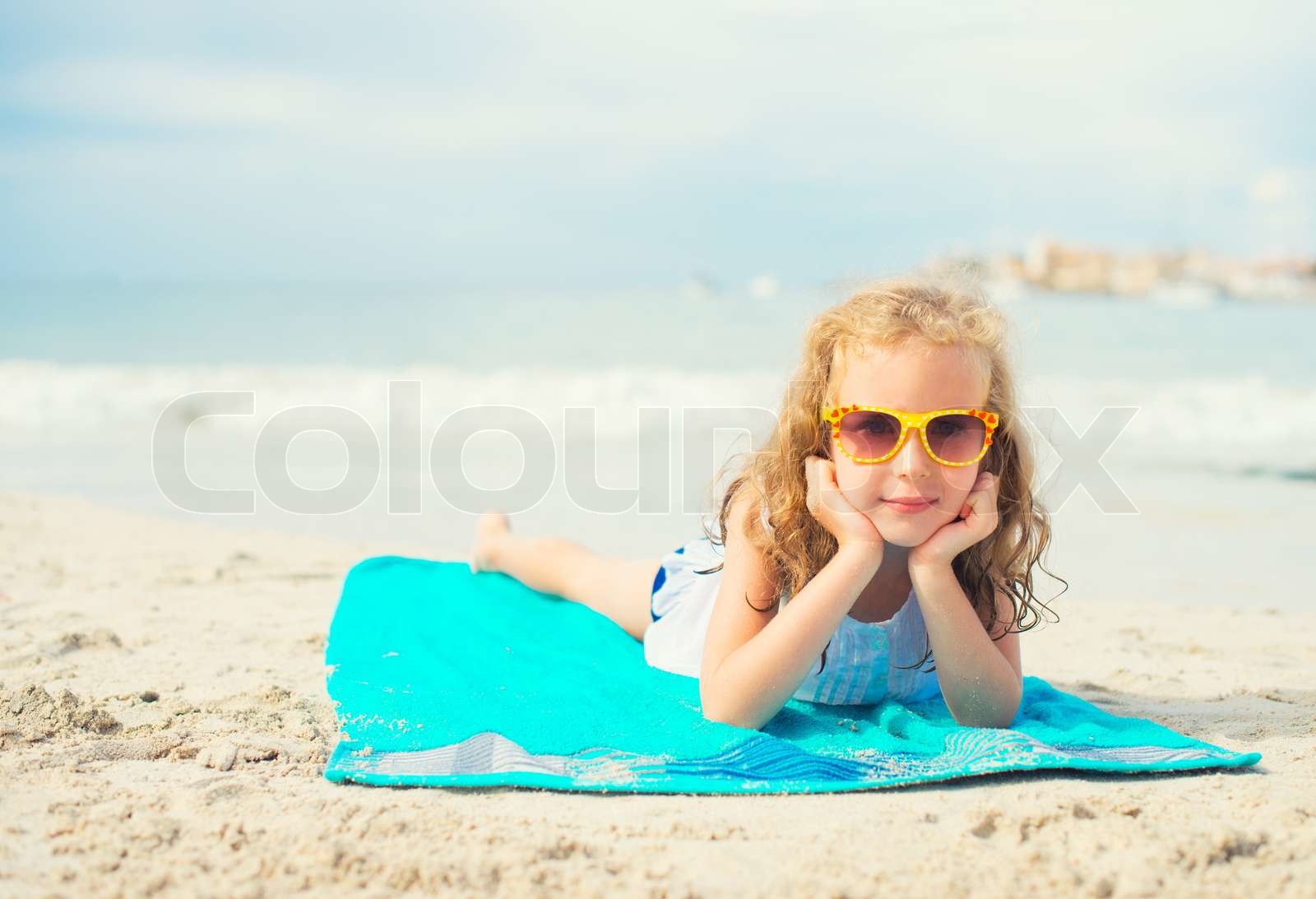 Little girl sunbathing on the beach. Place for text. | Stock image ...