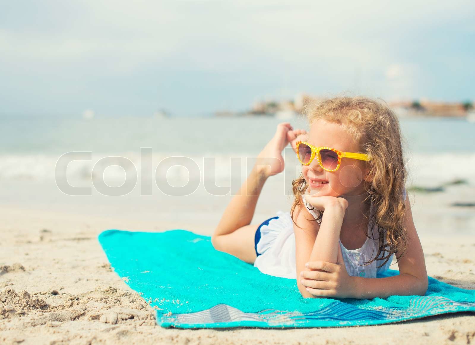 Little girl sunbathing on the beach. Place for text. | Stock image ...