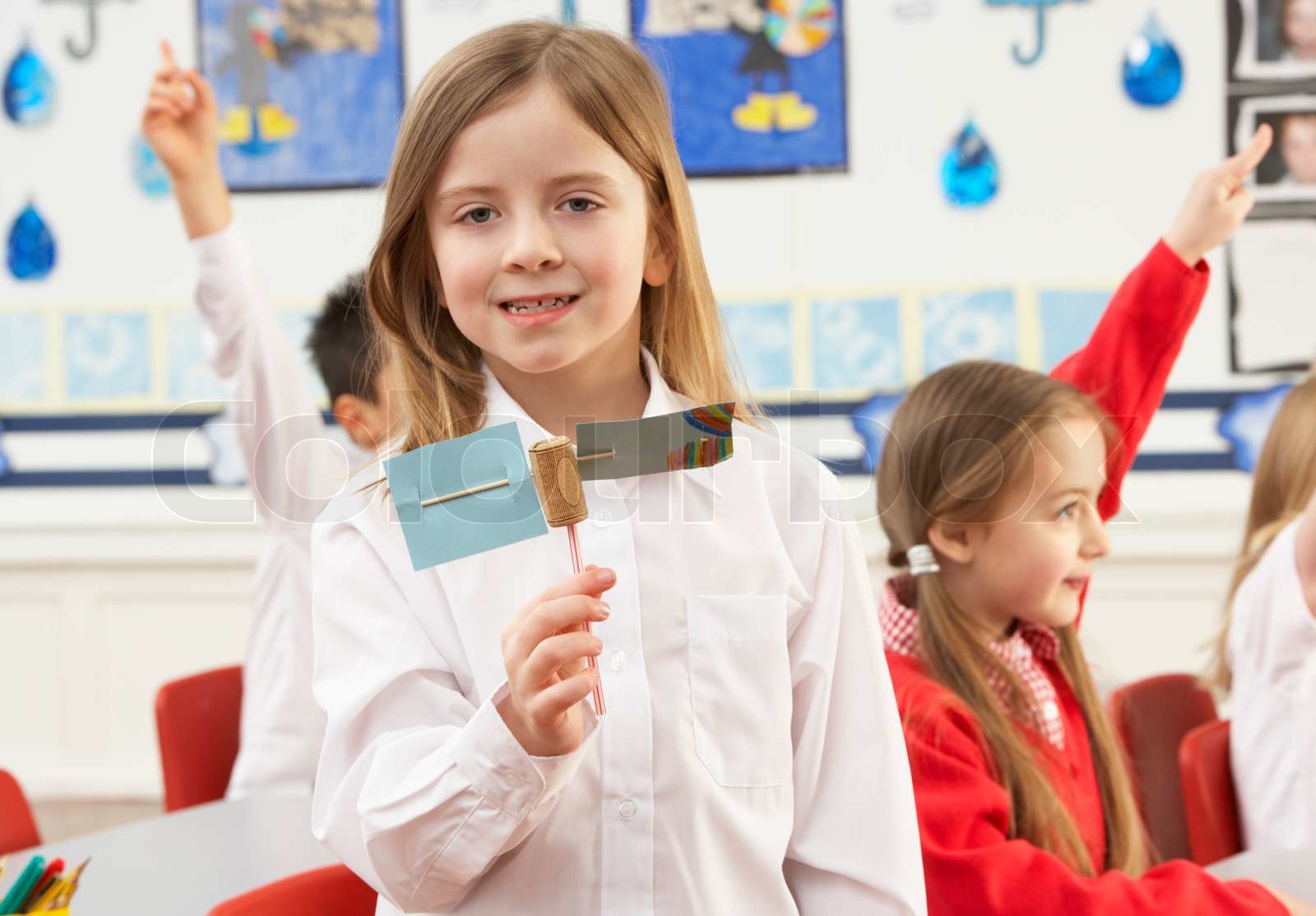 Group Of Primary Schoolchildren And Teacher Having lesson In Classroom ...