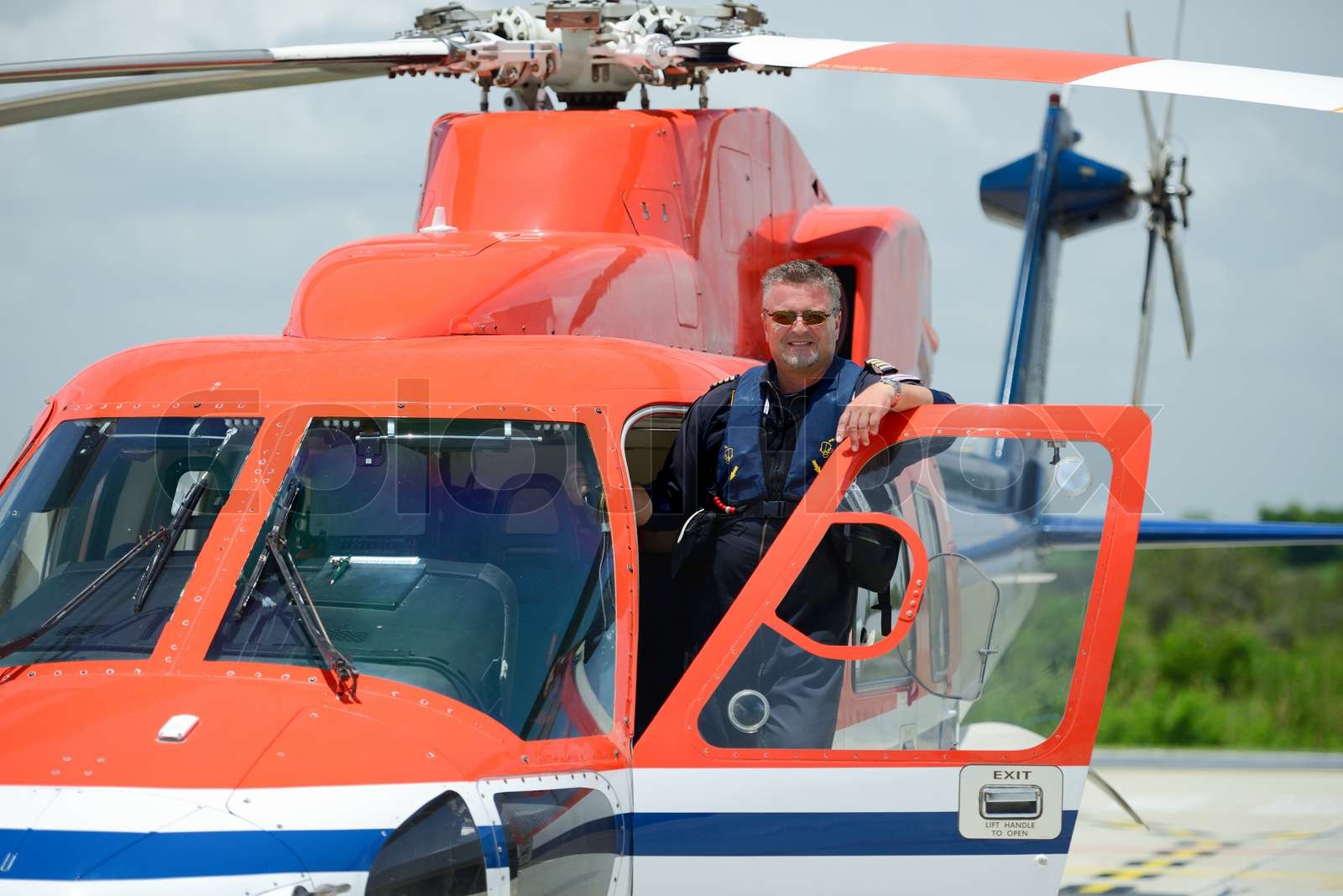 offshore helicopter pilot is standing on helicopter cockpit | Stock ...