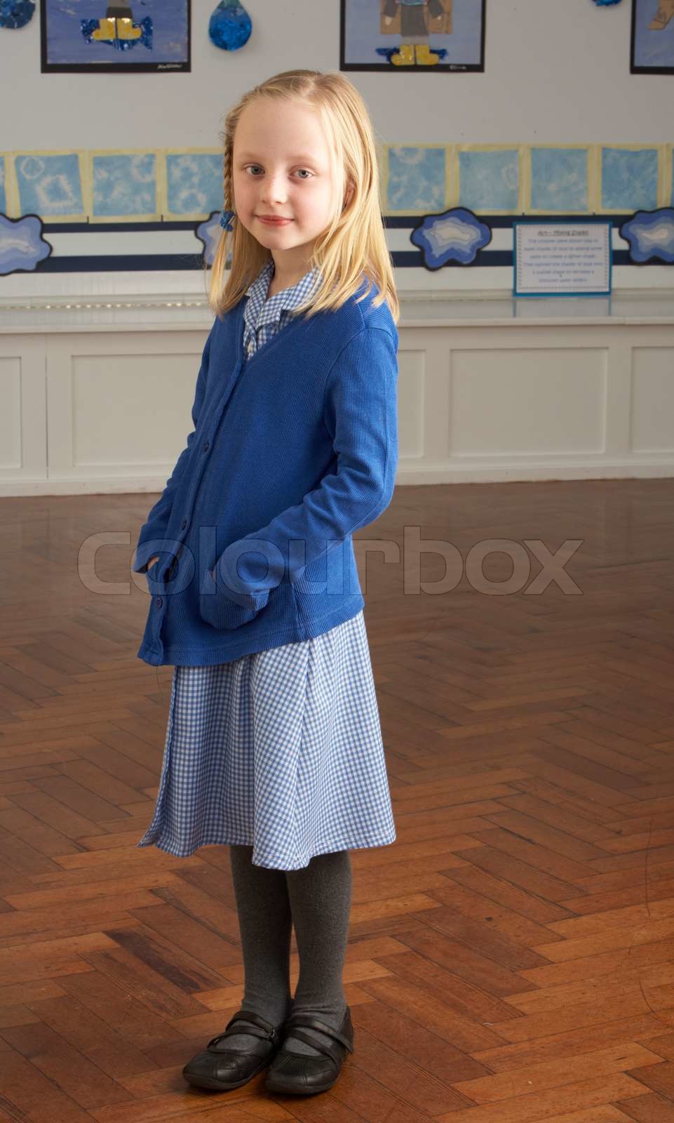 Portrait Of Female Primary School Pupil Standing In Classroom | Stock ...