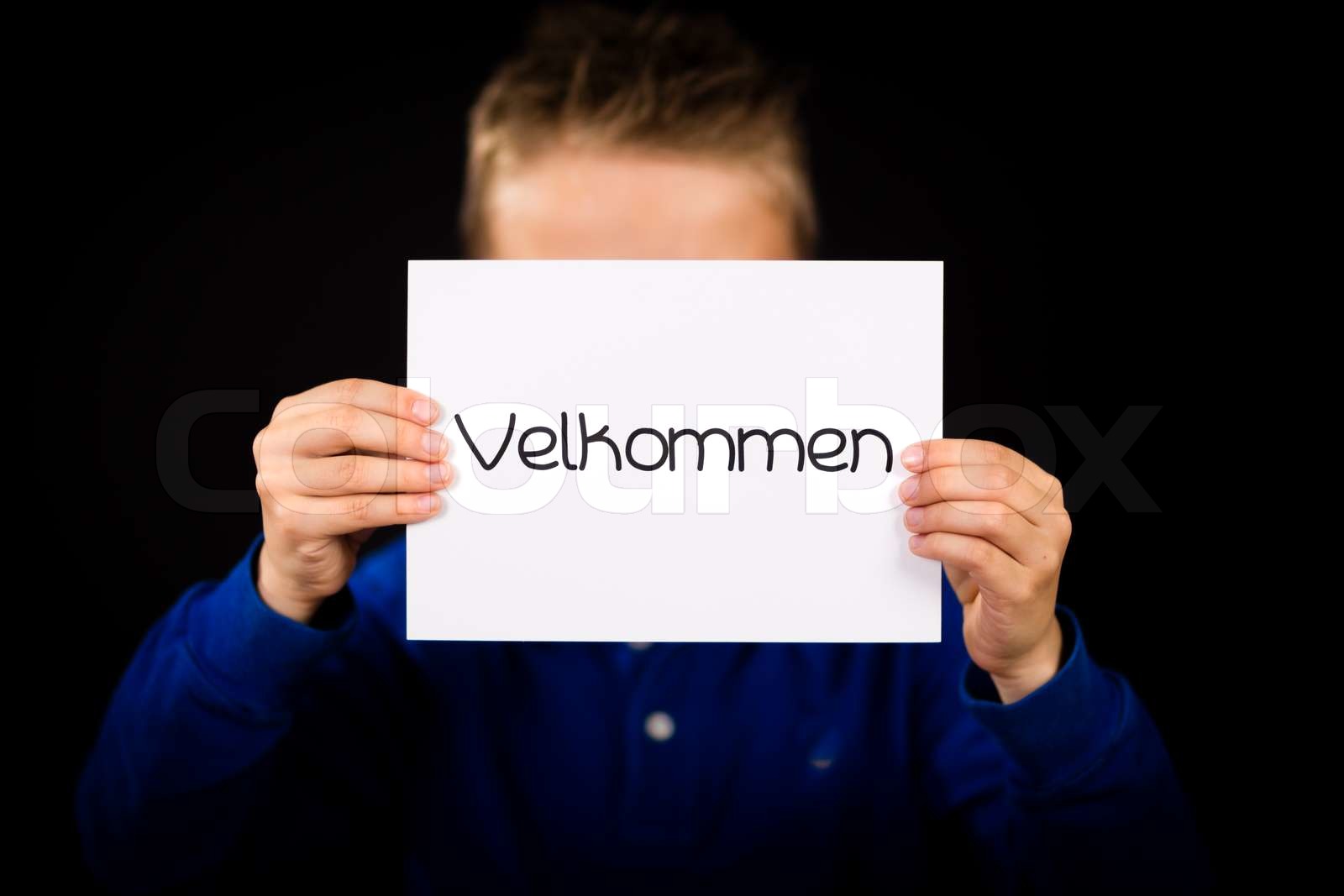 Child holding sign with Danish word Velkommen - Welcome | Stock image ...