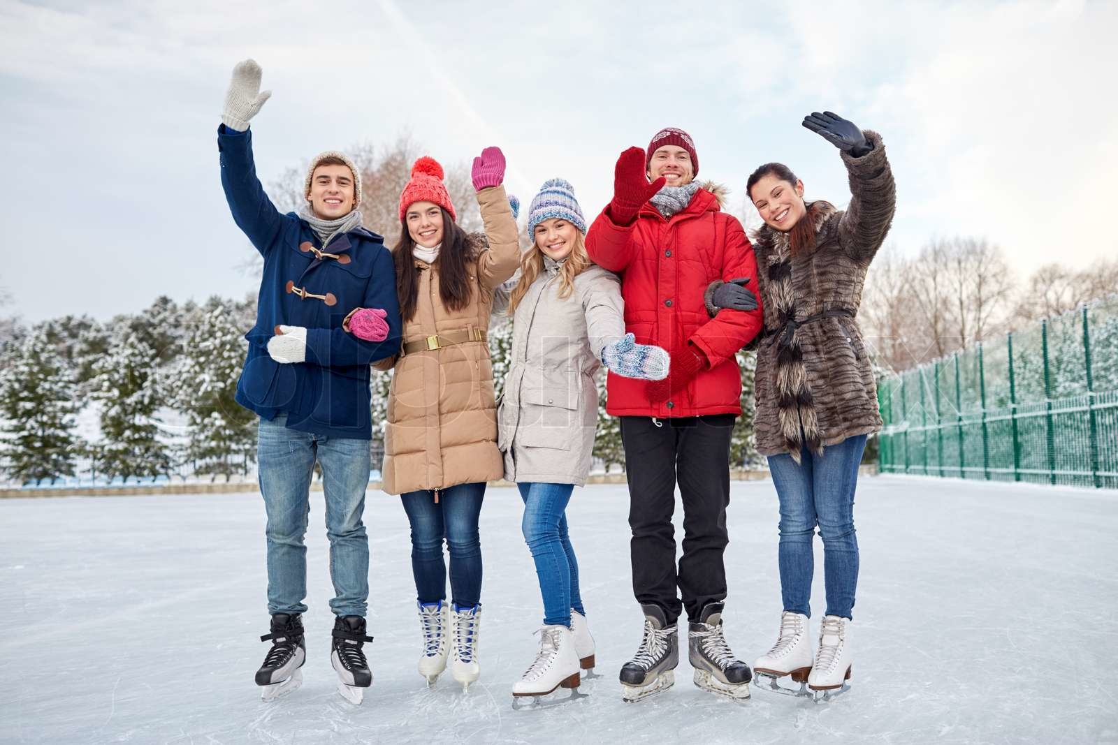 happy friends ice skating on rink outdoors | Stock image | Colourbox