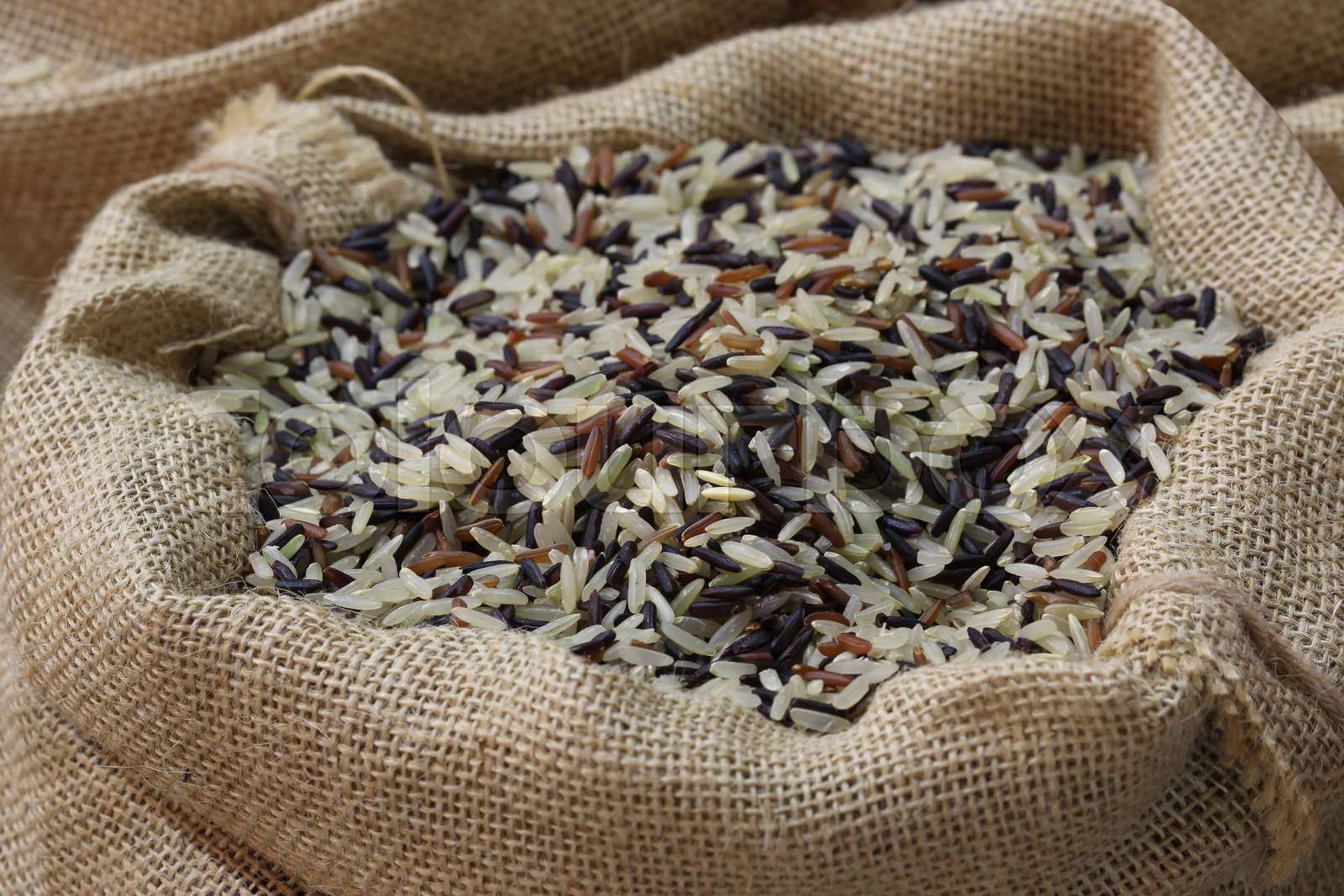 close up organic rice in sack bag | Stock image | Colourbox