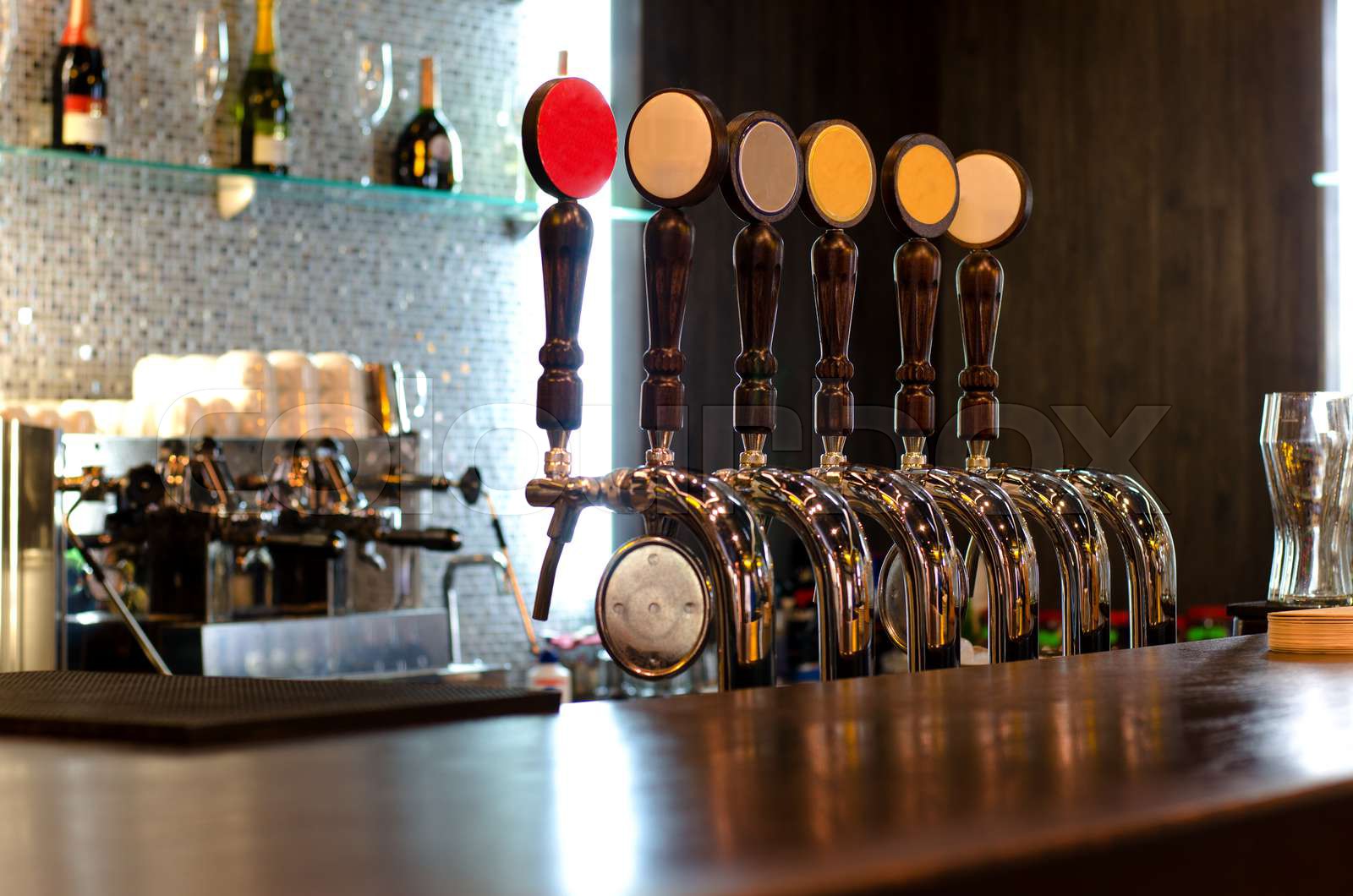 Beer taps behind a bar counter | Stock image | Colourbox