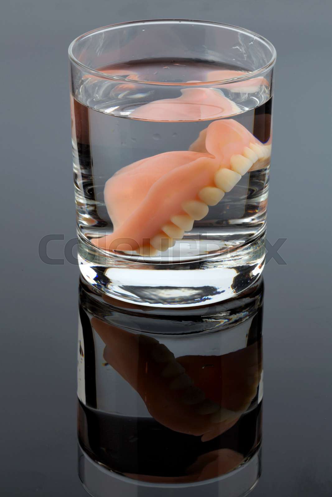 dentures in water glass | Stock image | Colourbox