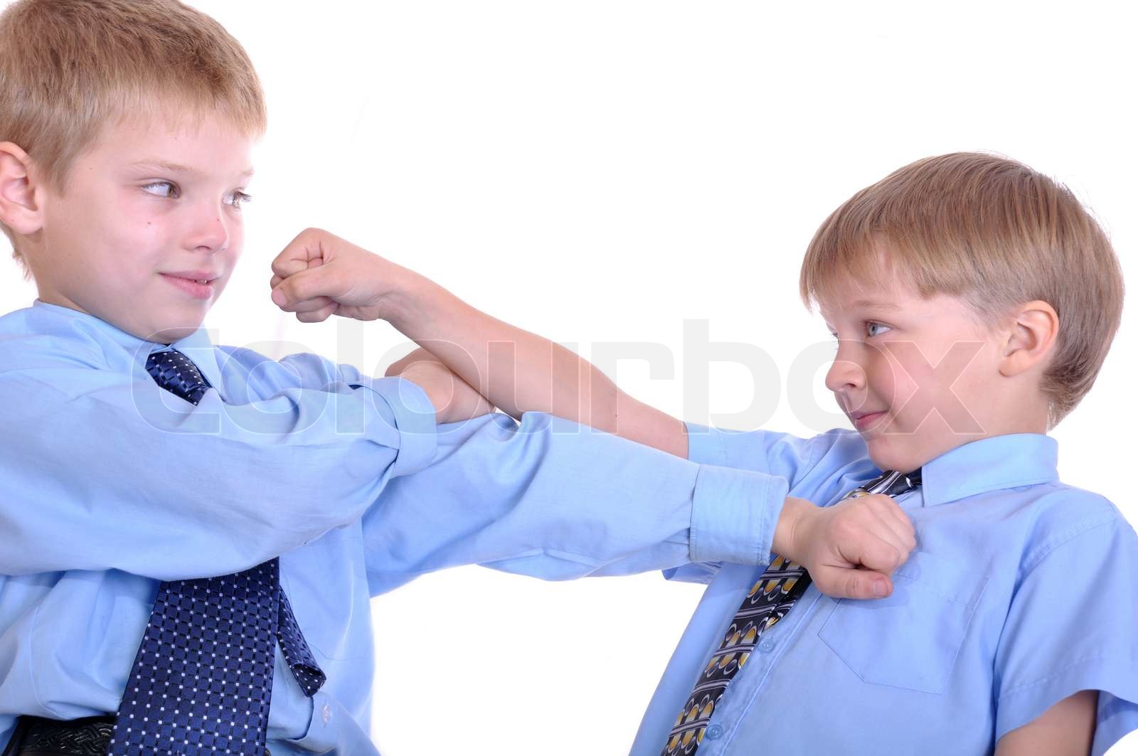 Two schoolboys fighting. Isolated over white. | Stock image | Colourbox