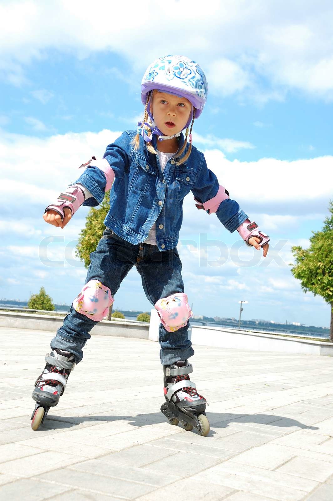 little girl doing her first steps in rollerblading | Stock image ...