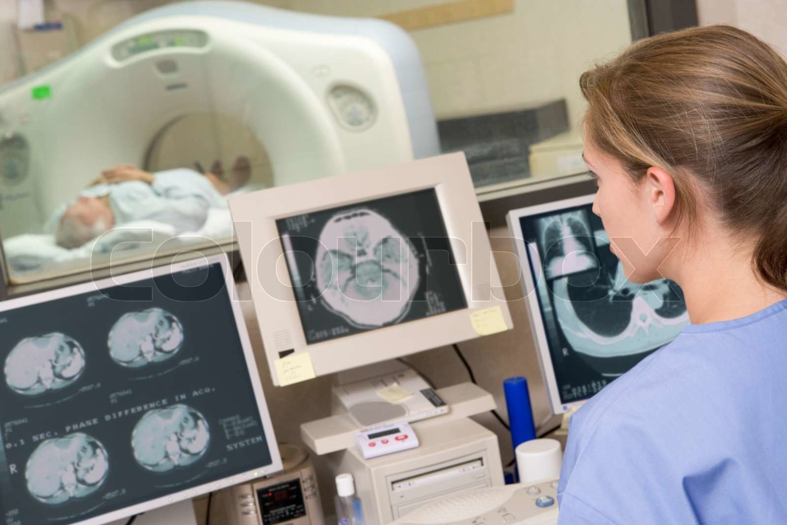 Nurse Monitoring Patient Having A Computerized Axial Tomography (CAT ...