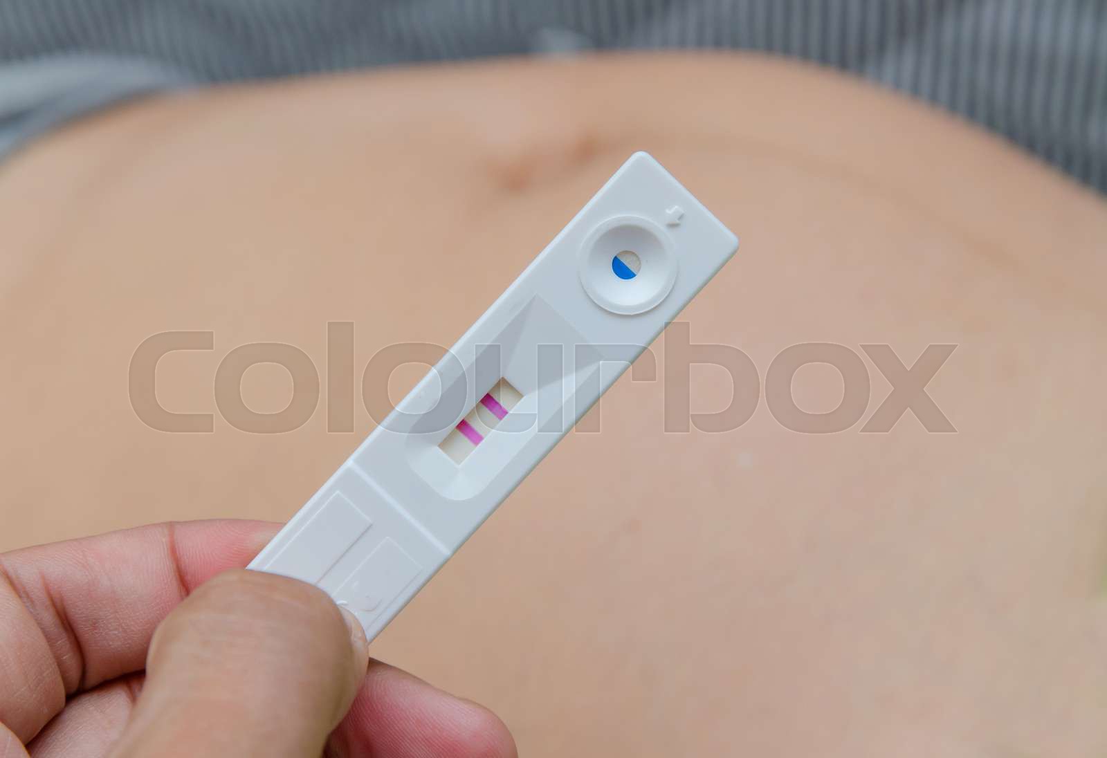 holding positive pregnancy test with two red stripes | Stock image ...
