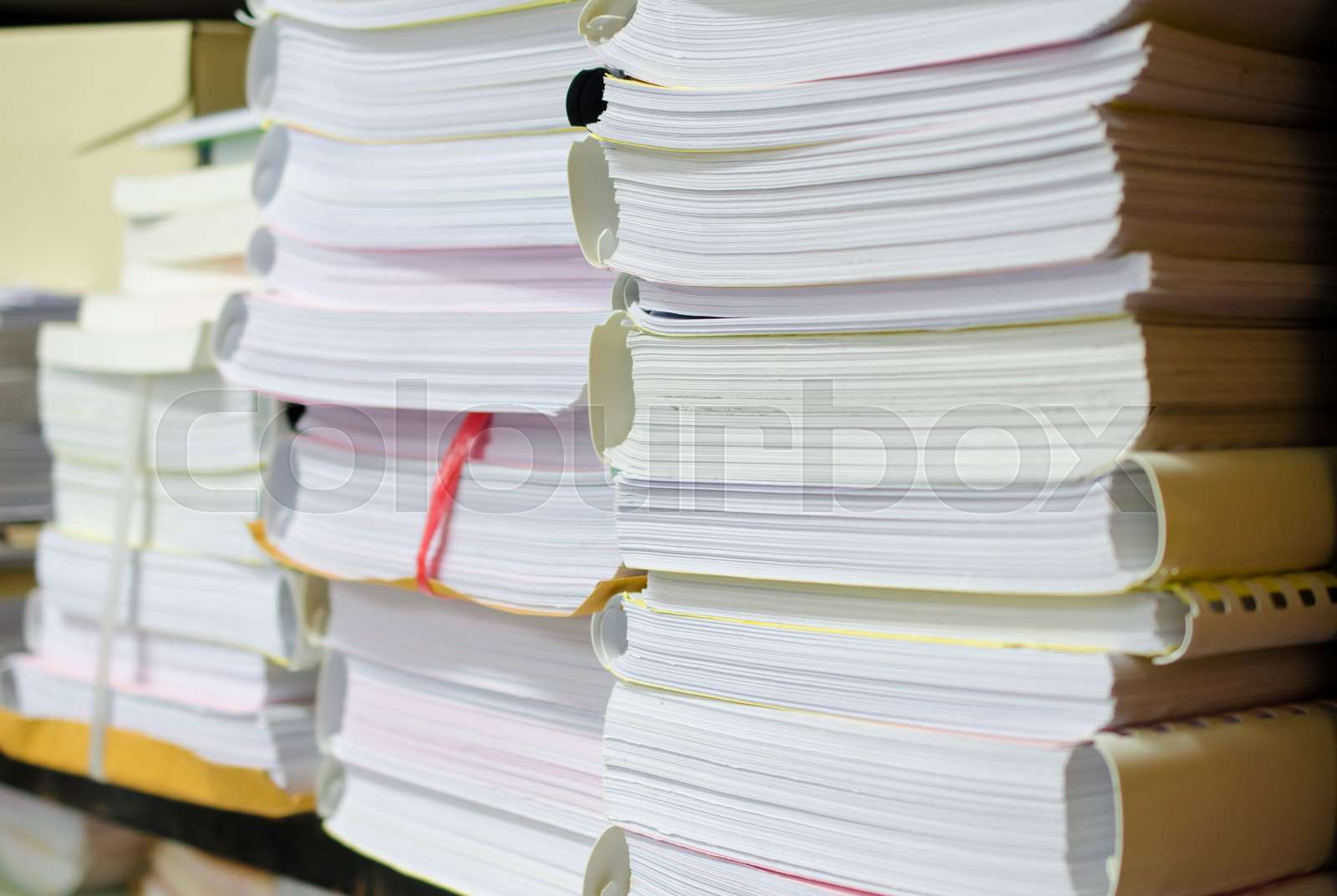 Pile of documents on desk stack up high waiting to be managed. | Stock ...