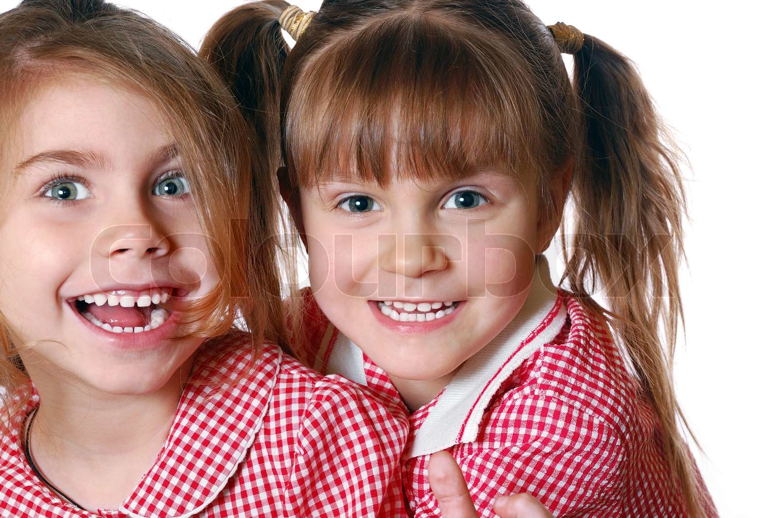 portrait of two happy smiling girls against white | Stock image | Colourbox