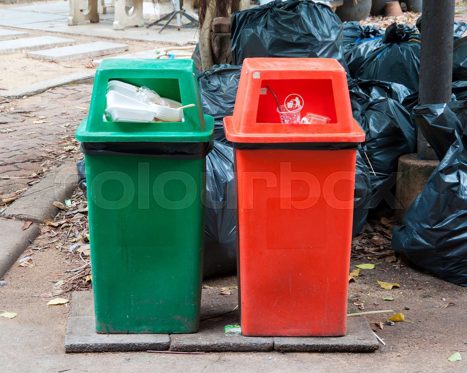 overfilled trash of large bins for rubbish, recycling and garden waste ...