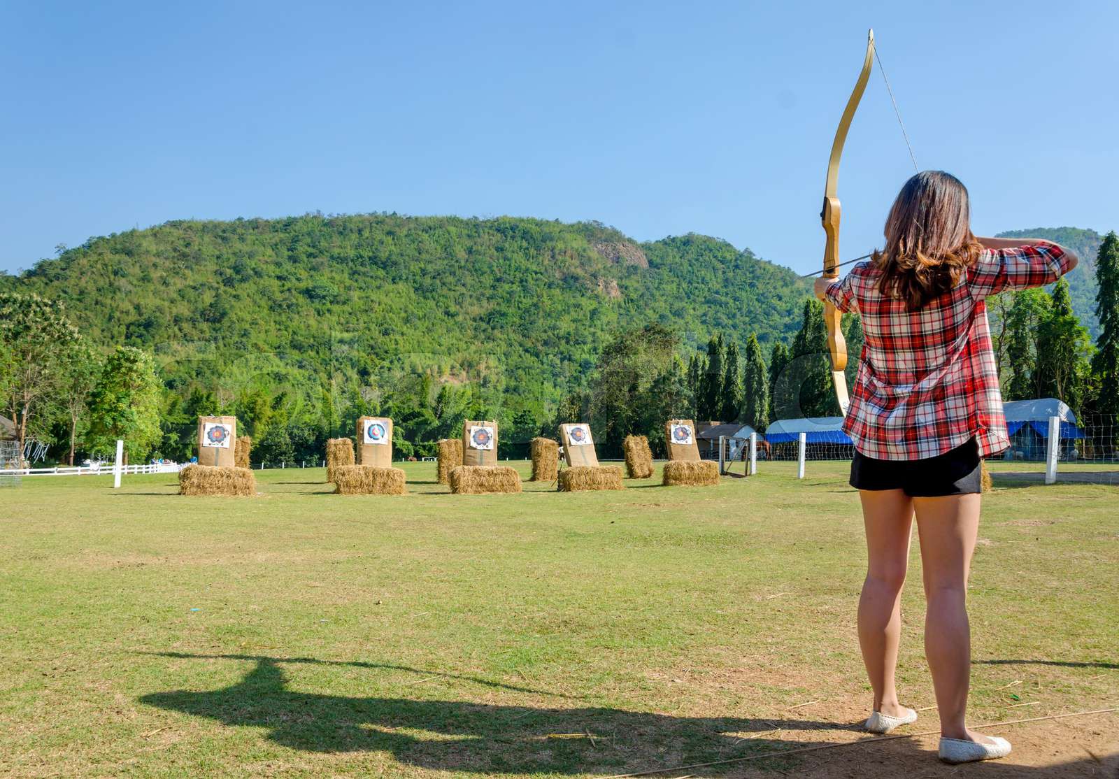 Female archer aiming at target | Stock image | Colourbox