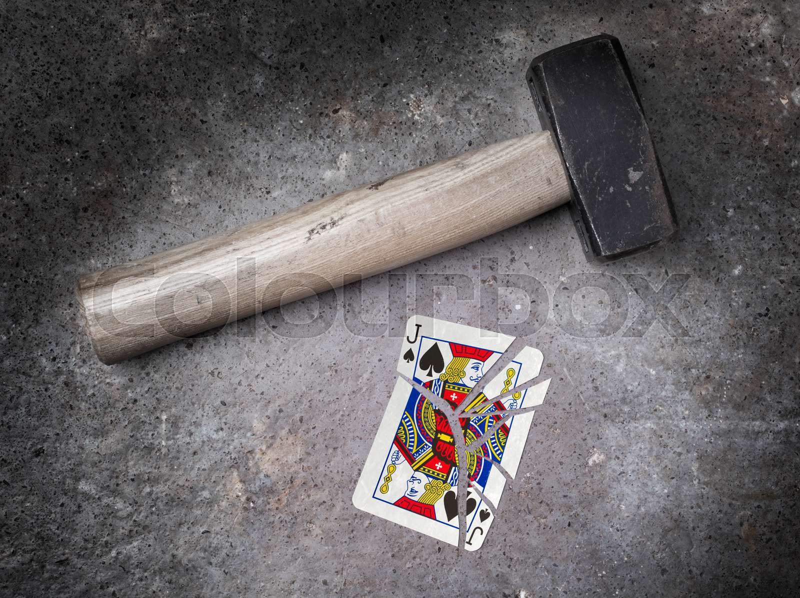 Hammer with a broken card, jack of spades | Stock image | Colourbox