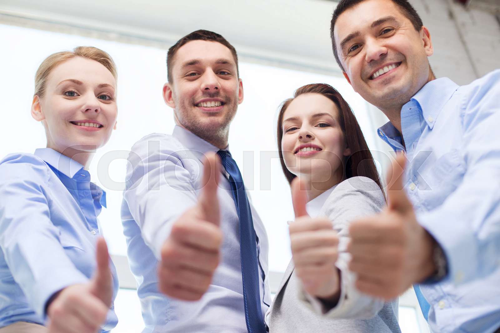 smiling business people showing thumbs up | Stock image | Colourbox