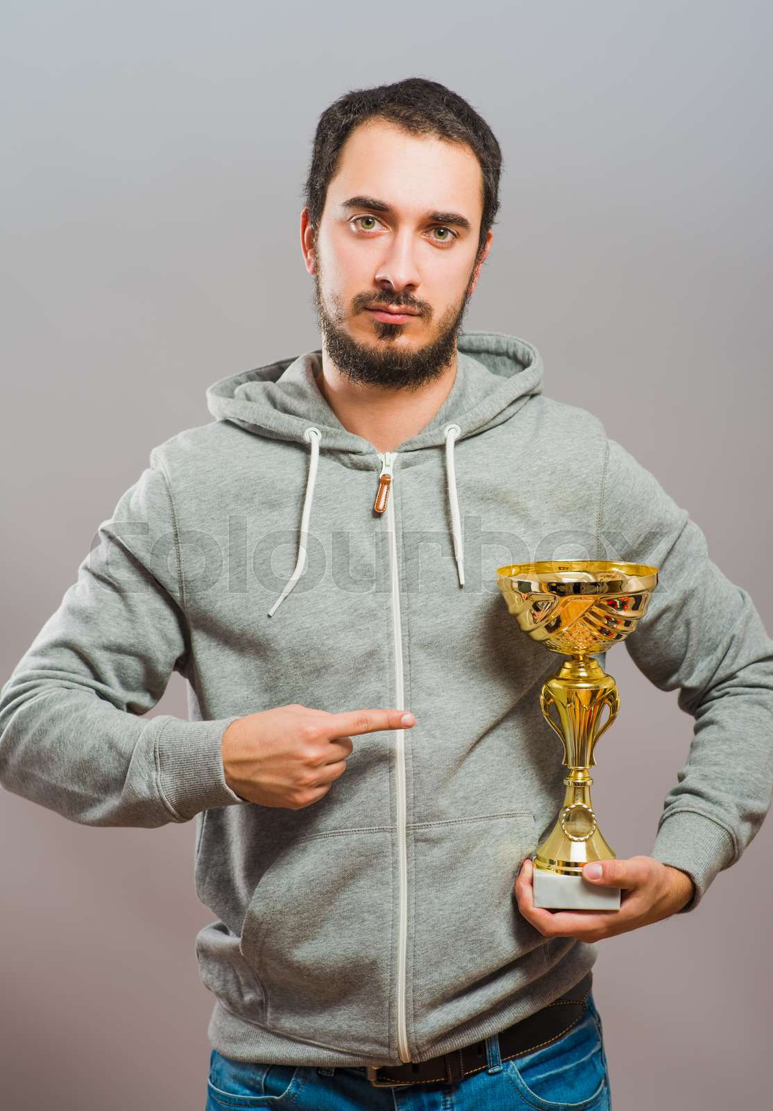 man raising his trophy | Stock image | Colourbox