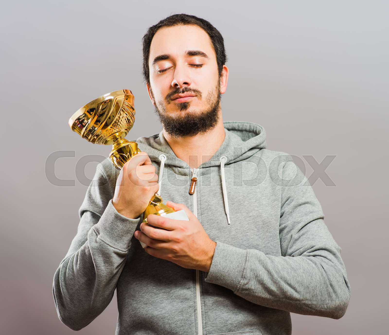 man raising his trophy | Stock image | Colourbox