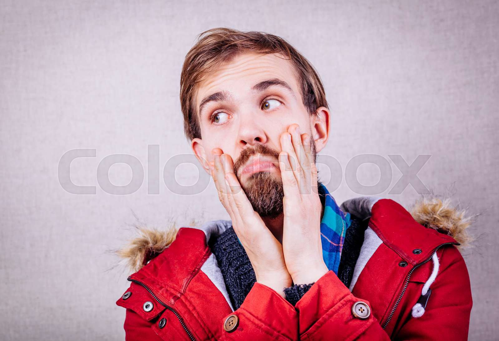 a young man dragging face down with hands | Stock image | Colourbox