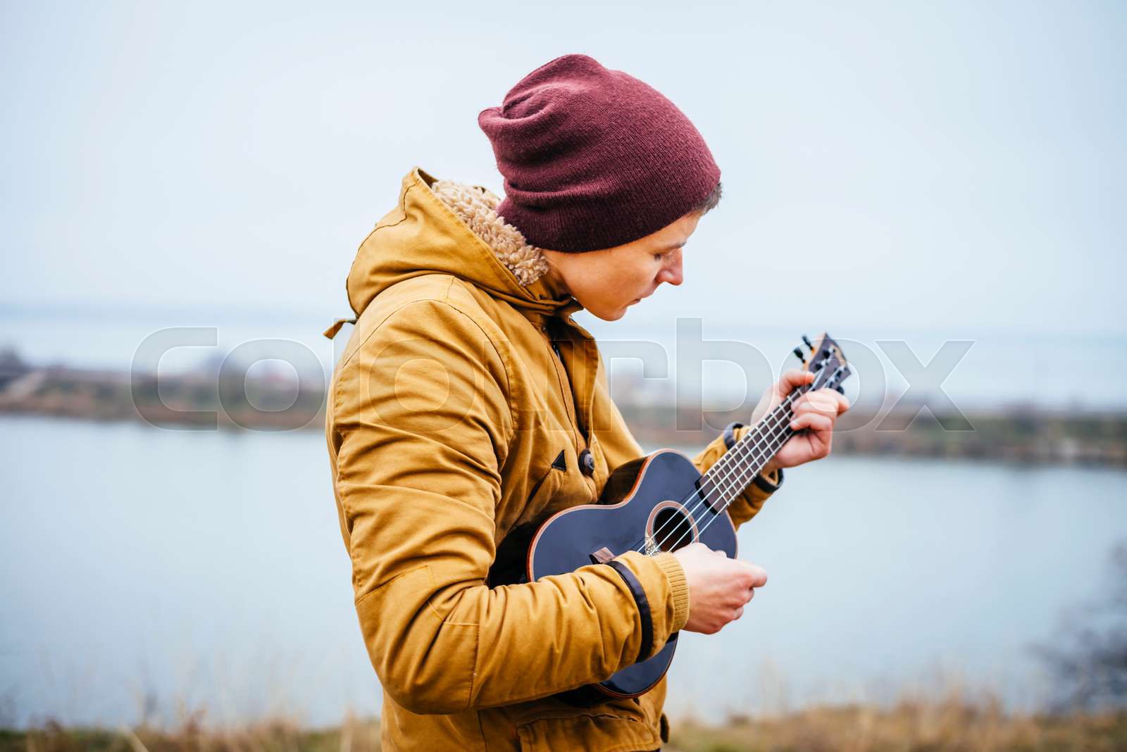 young man playing ukulele | Stock image | Colourbox