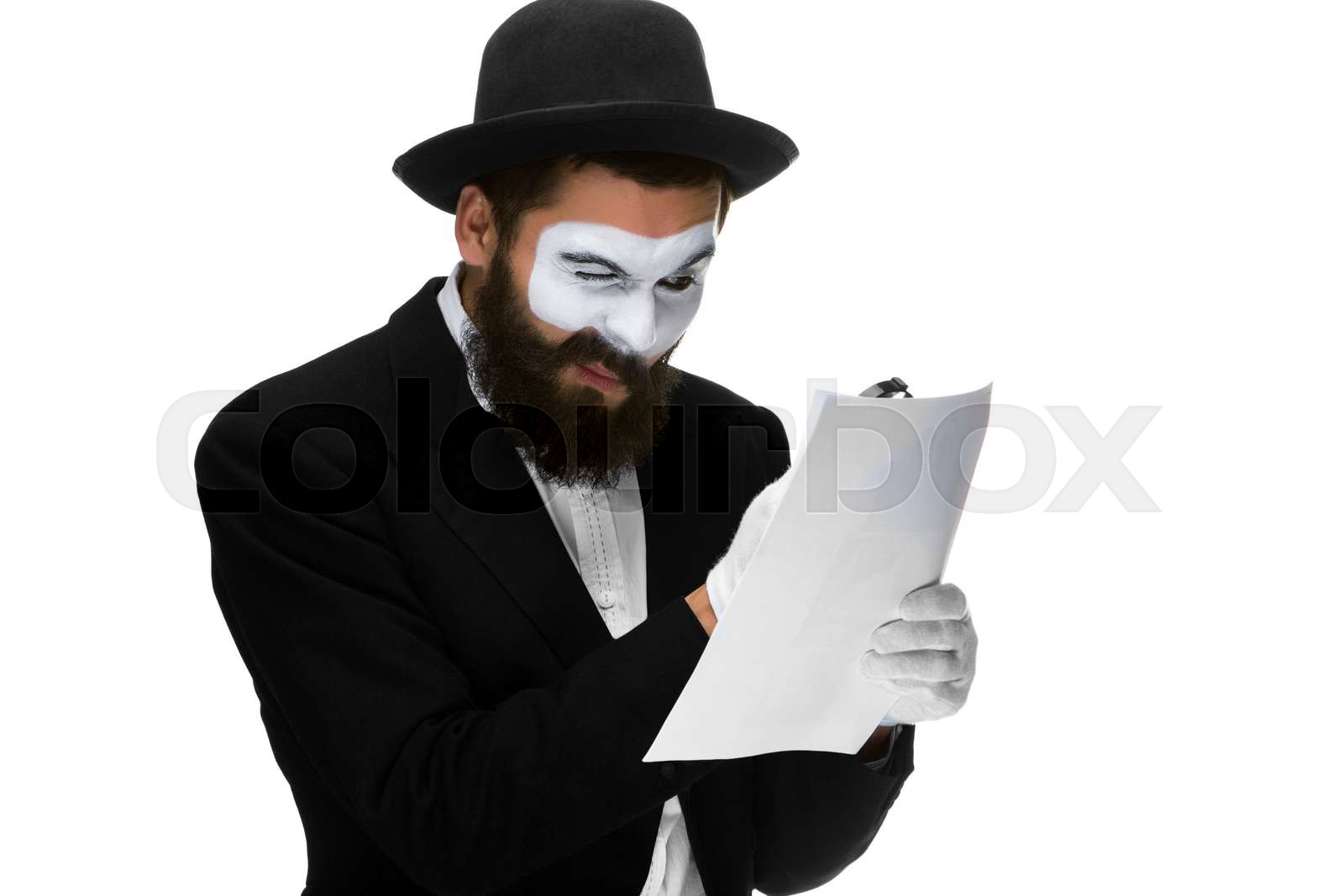Man with a face mime reading through magnifying glass | Stock image ...