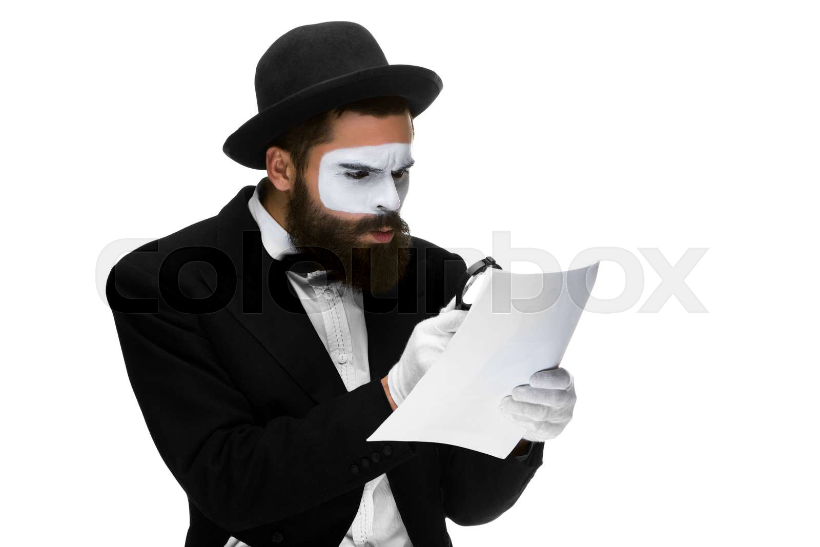 Man with a face mime reading through magnifying glass | Stock image ...
