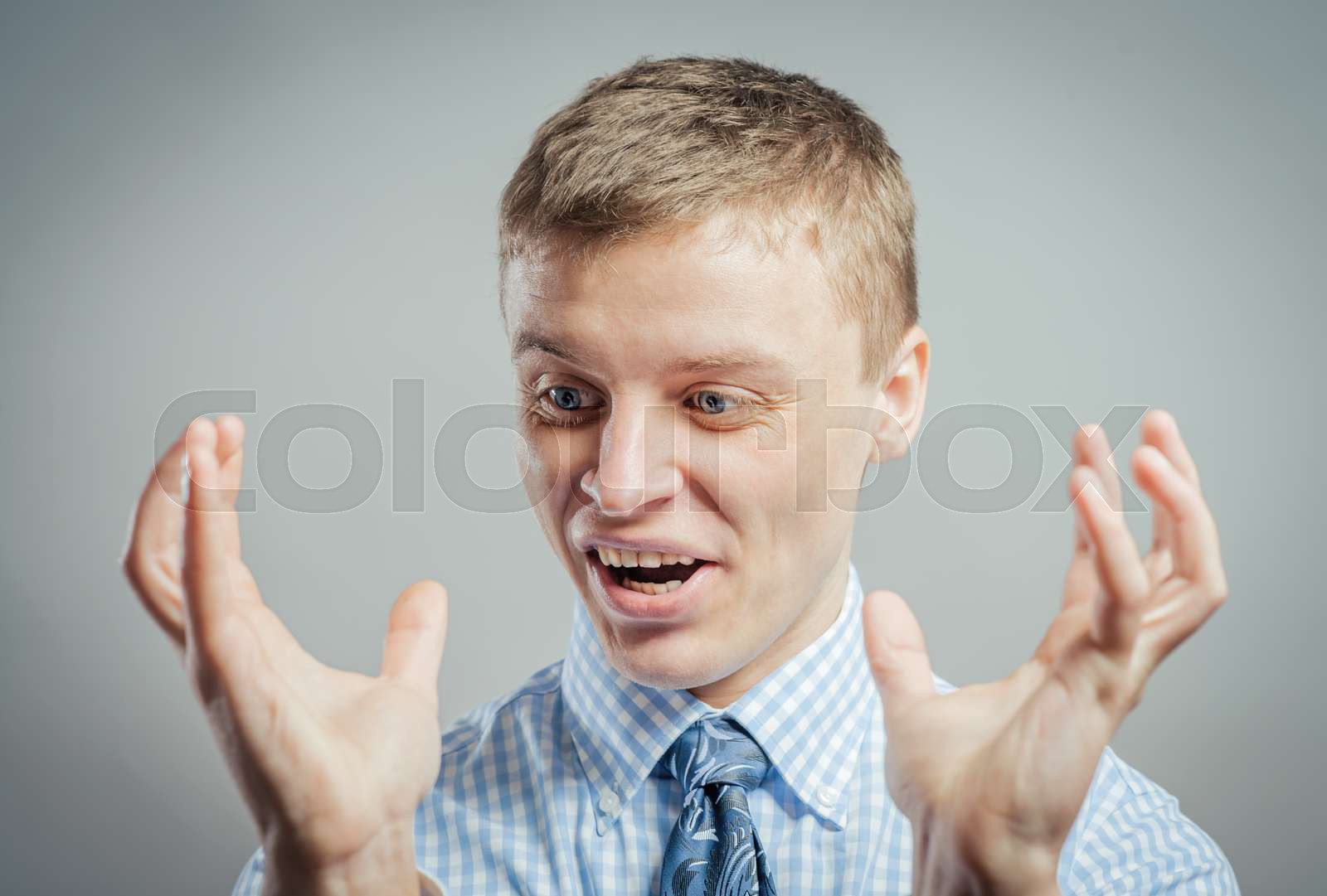 young man looking shocked and surprised in full disbelief hands up in ...