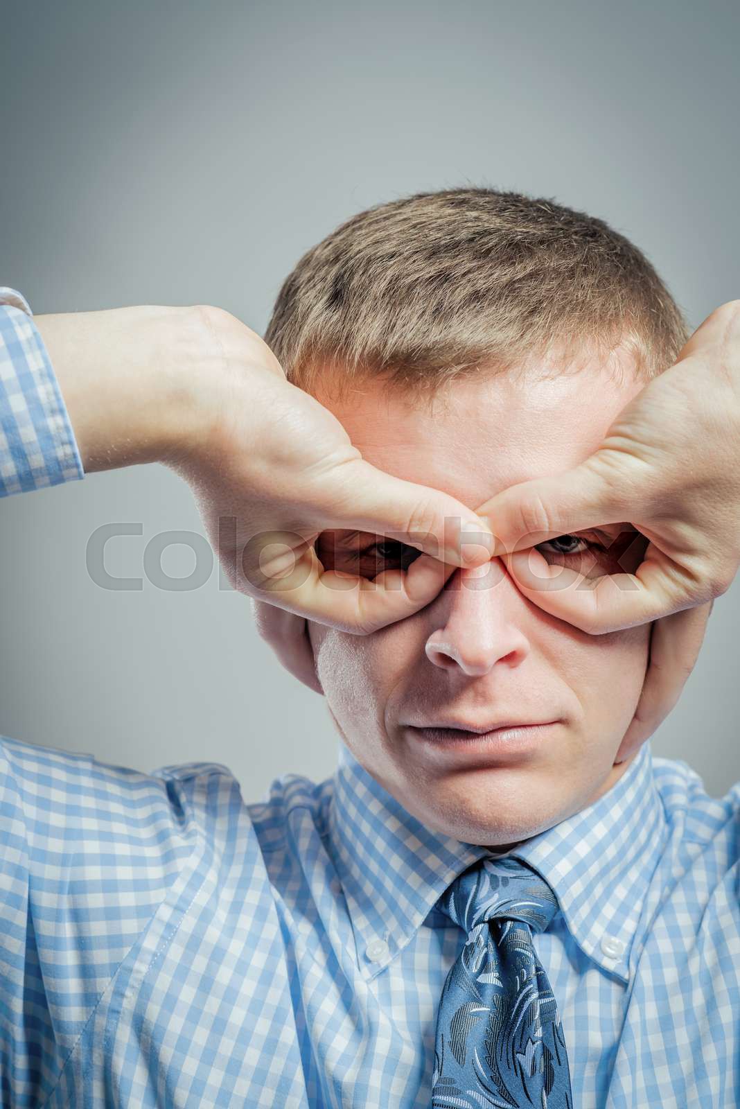 Funny man with hand over eyes, looking through fingers | Stock image ...
