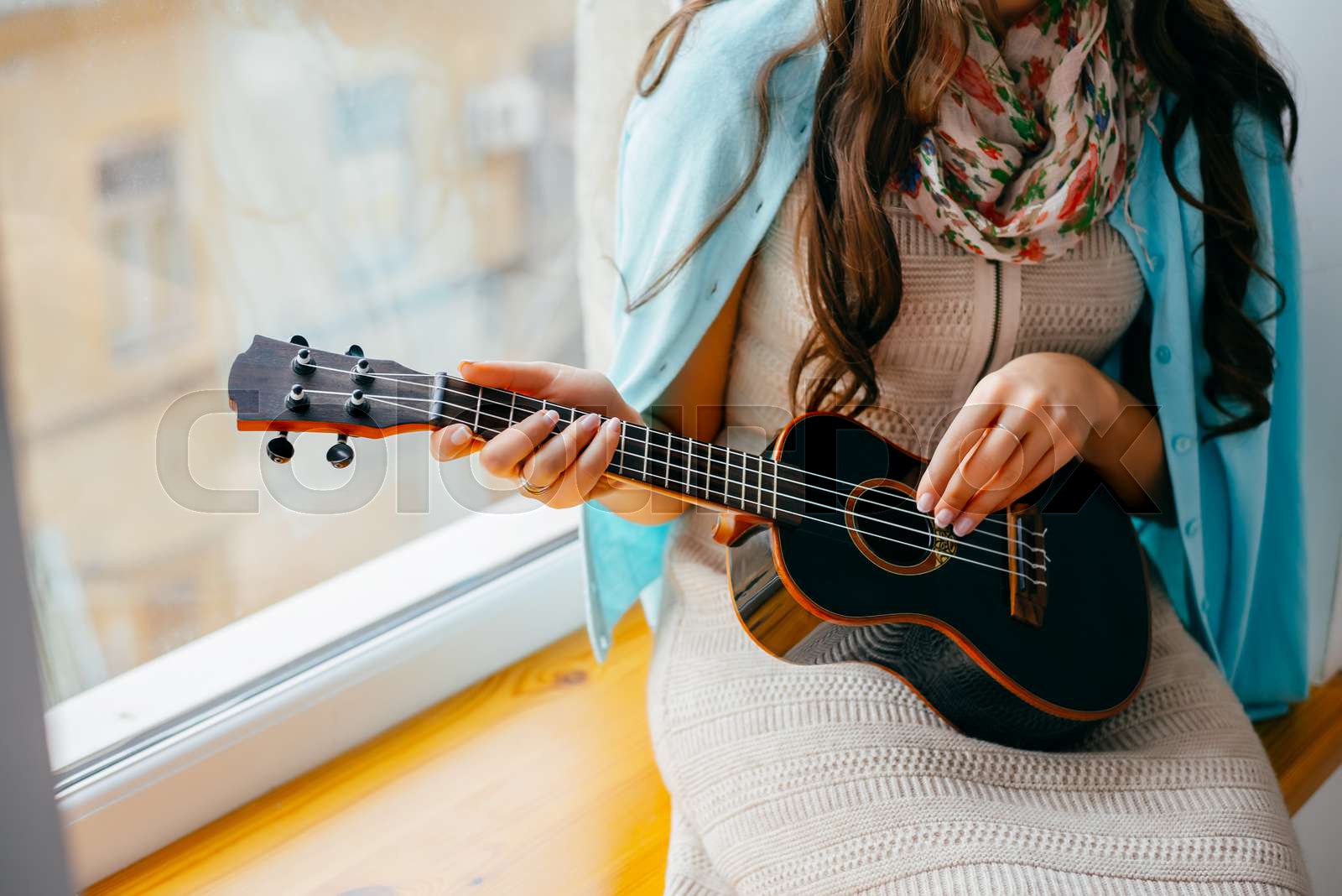 girl sitting on the window. playing guitar | Stock image | Colourbox