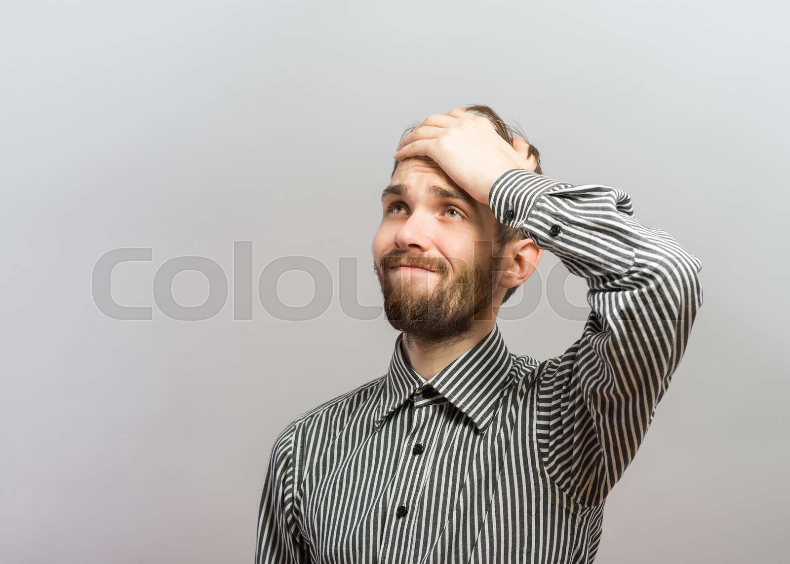 Closeup portrait, goofy, silly young man, slapping hand on head ...