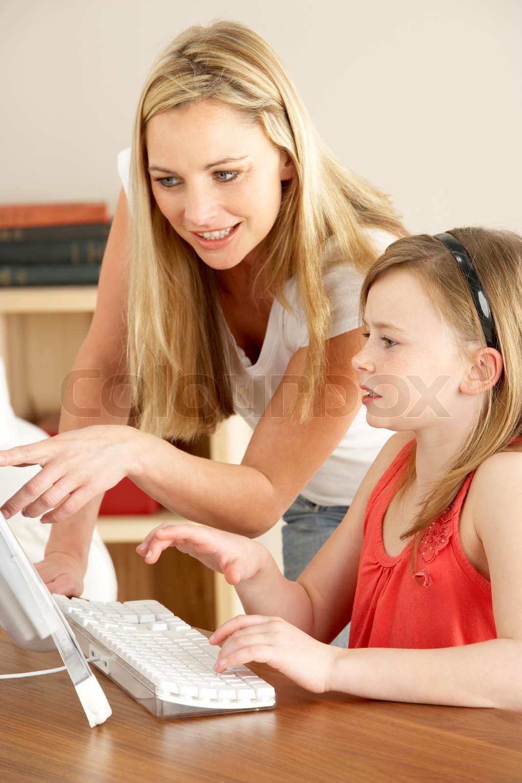 Mother And Daughter At Home Using Computer | Stock image | Colourbox