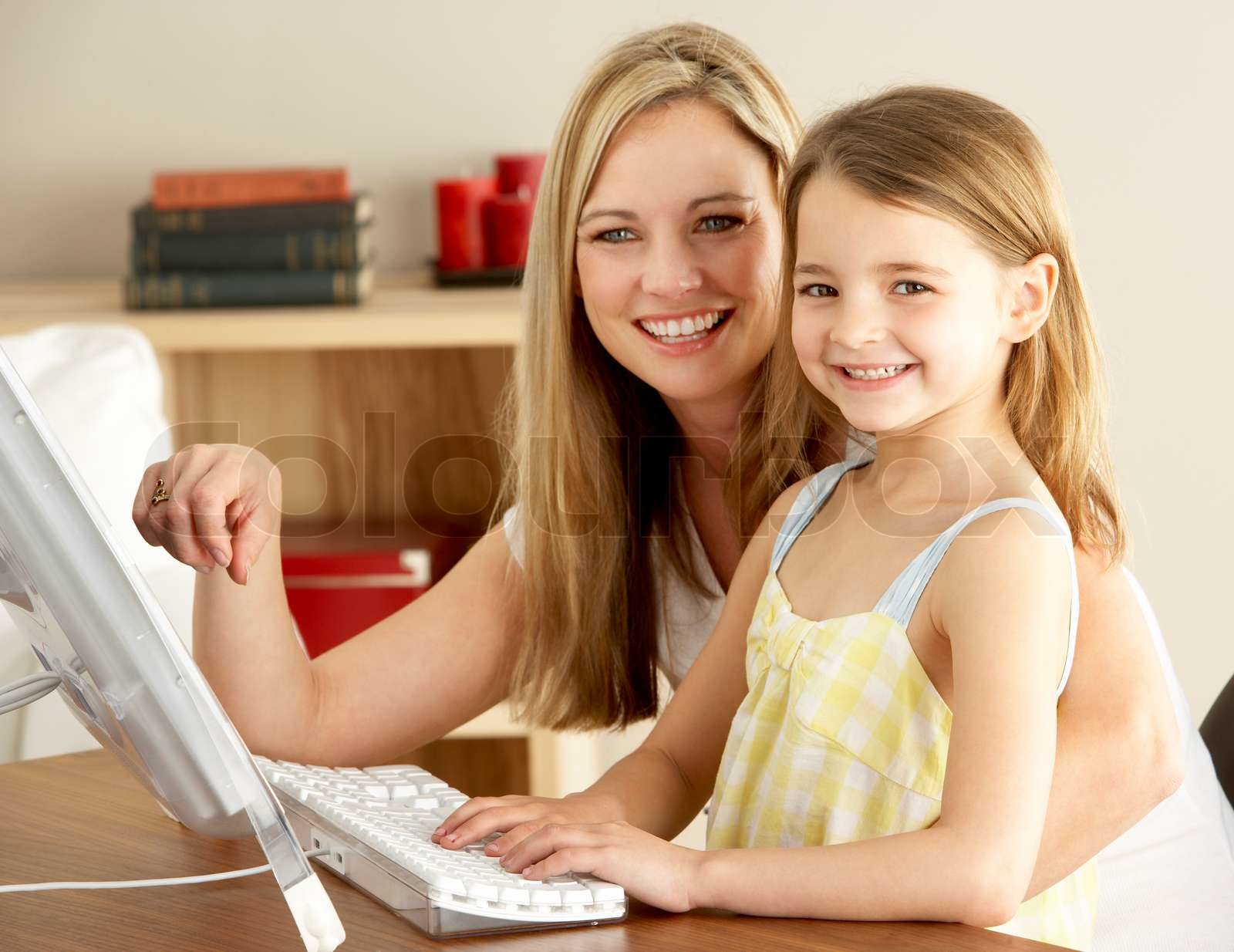 Mother And Daughter At Home Using Computer | Stock image | Colourbox