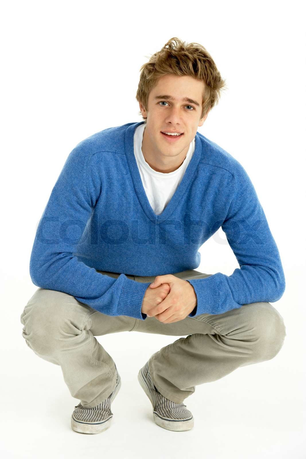 Young Man Crouching I Studio | Stock foto | Colourbox