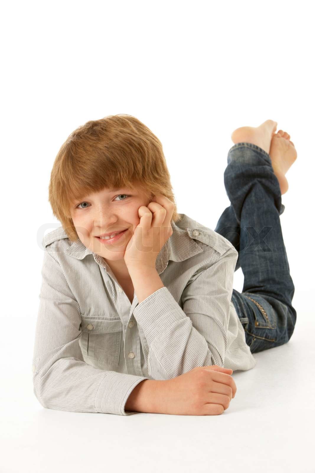 Young Boy Lying On Stomach In Studio | Stock image | Colourbox