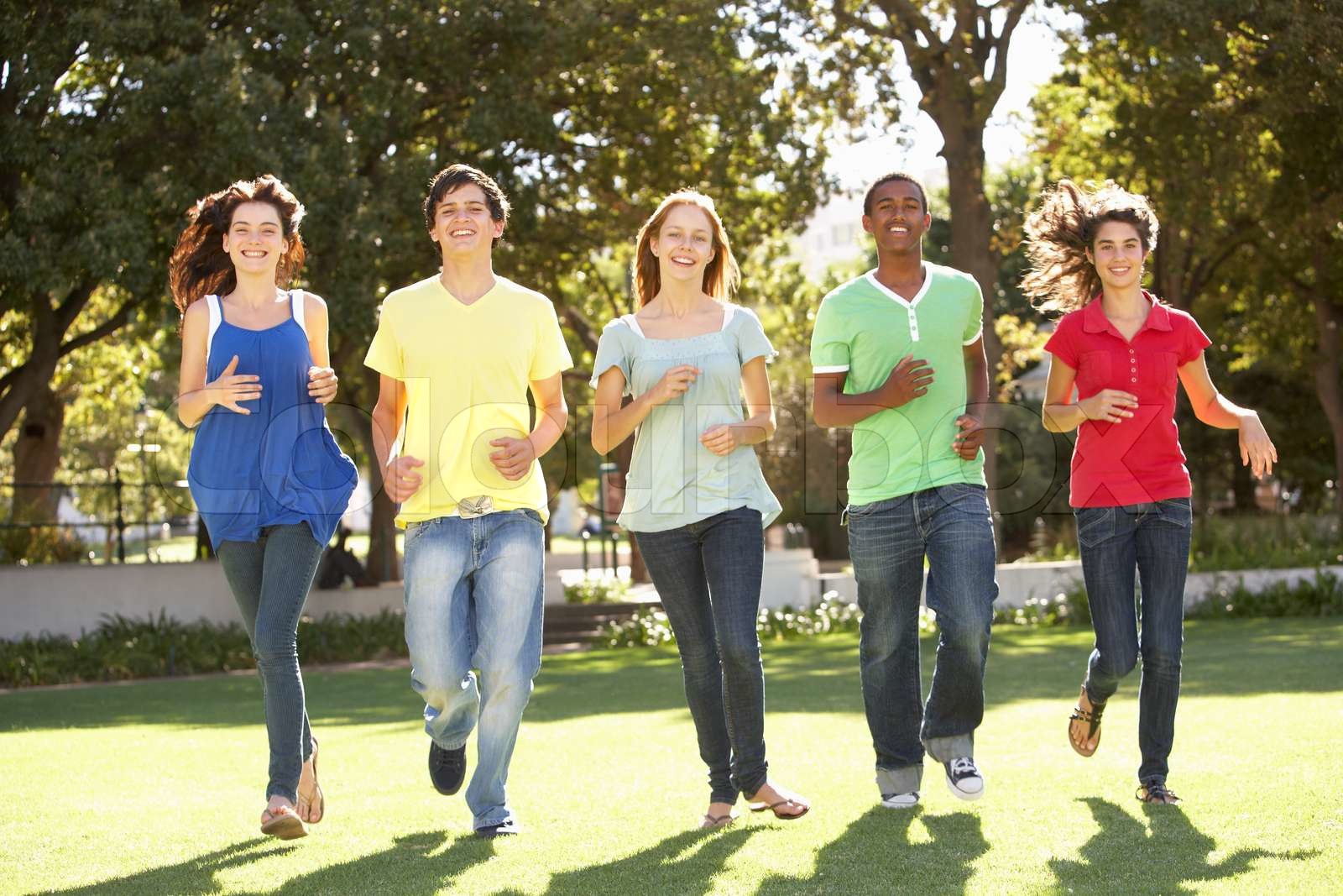 Group Of Teenagers Running Through Park | Stock image | Colourbox