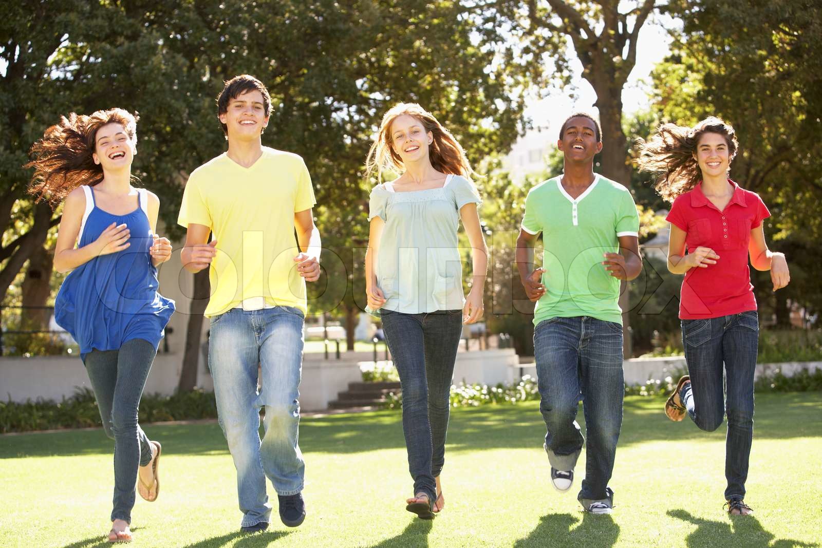Group Of Teenagers Running Through Park | Stock image | Colourbox