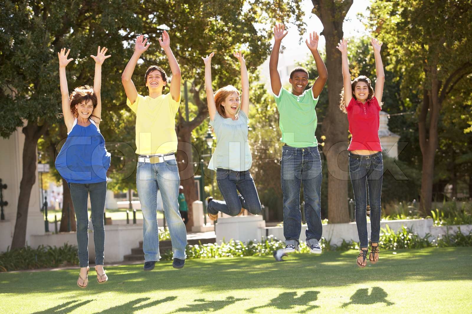 Group Of Teenagers Jumping In Air In Park | Stock image | Colourbox