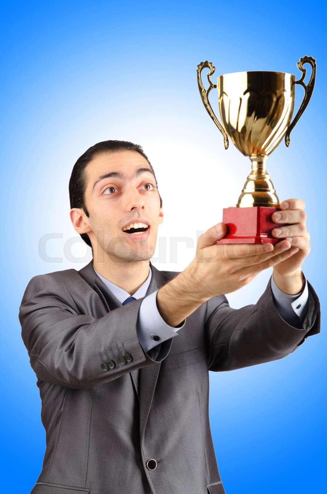 Man being awarded with golden cup | Stock image | Colourbox