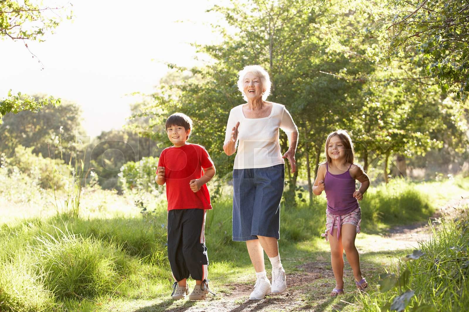 Grandmother Jogging In Park With Grandchildren | Stock image | Colourbox