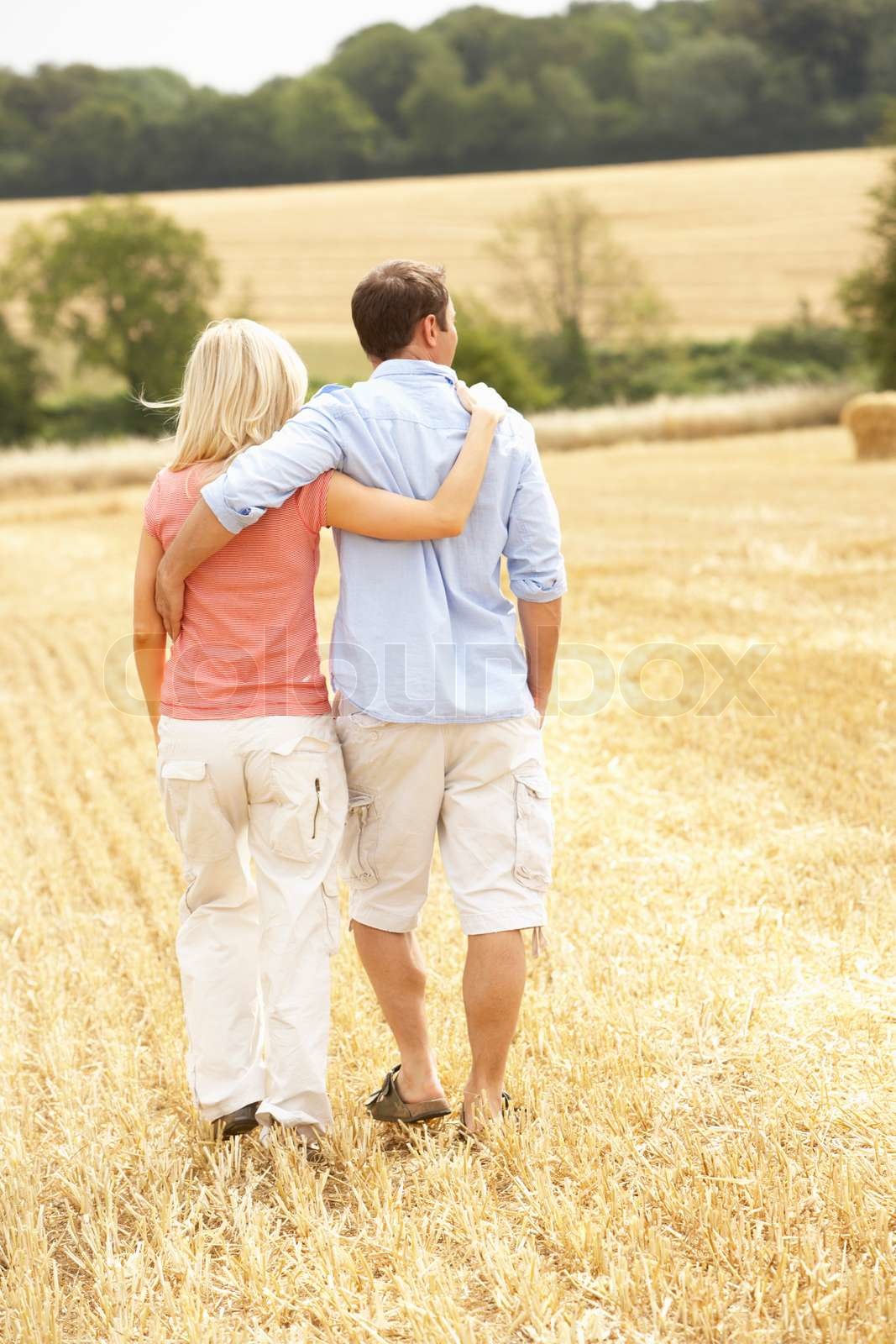 Couple Walking Together Through Summer Harvested Field | Stock image ...