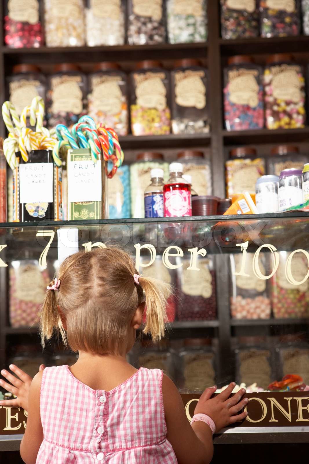 Excited Girl Standing In Sweet Shop | Stock image | Colourbox