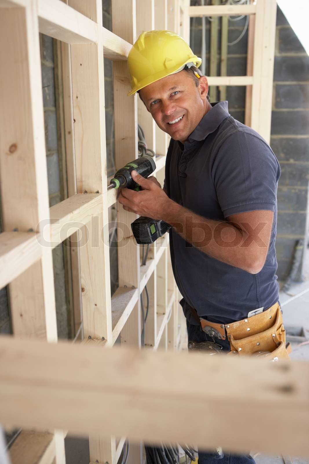 Construction Worker Building Timber Frame In New Home | Stock image ...